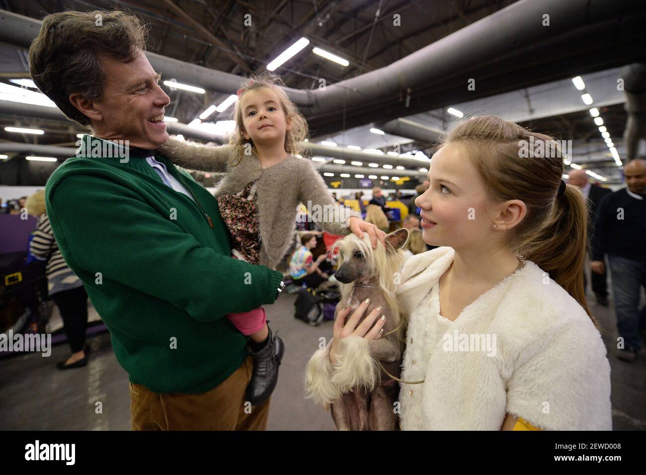 Larry Marsh holds his four year-old daughter Simone Marsh as she pets ...