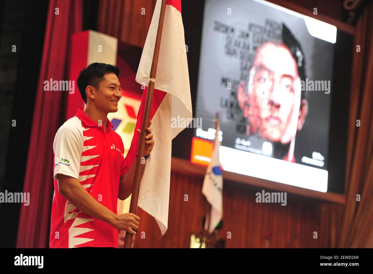 Indonesian racer Rio Haryanto holds Indonesian national flag during a ...