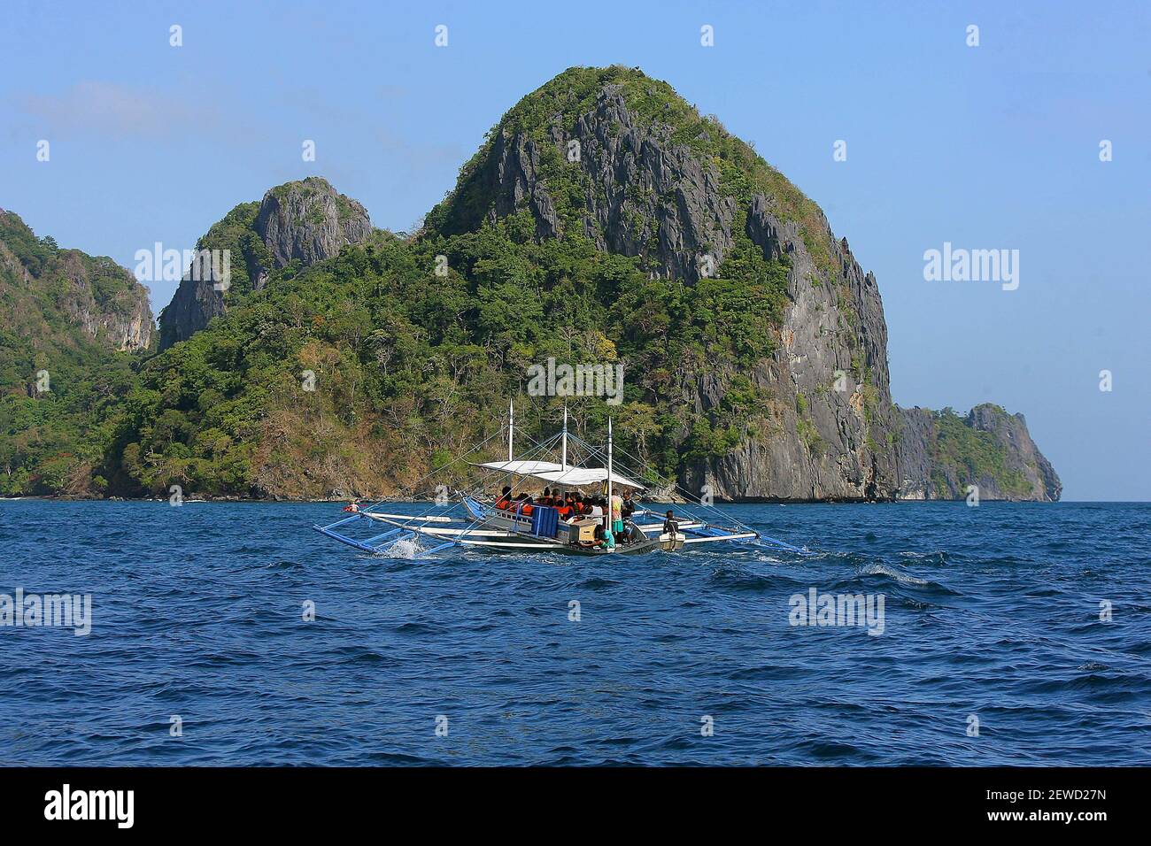 A ferry carrying tourists sails in Palawan Province, the Philippines ...