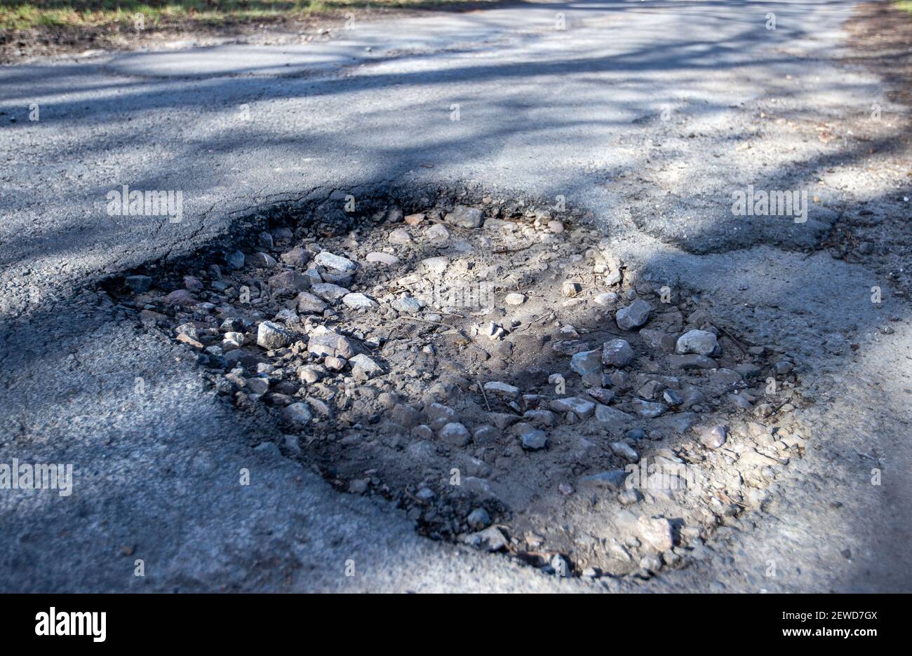 Gottesgabe, Germany. 26th Feb, 2021. A deep pothole in an alley. The ...