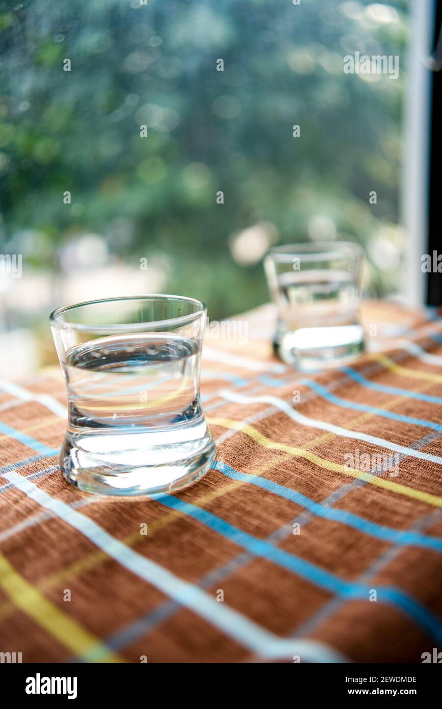 Two glasses of water on the table by the window Stock Photo - Alamy