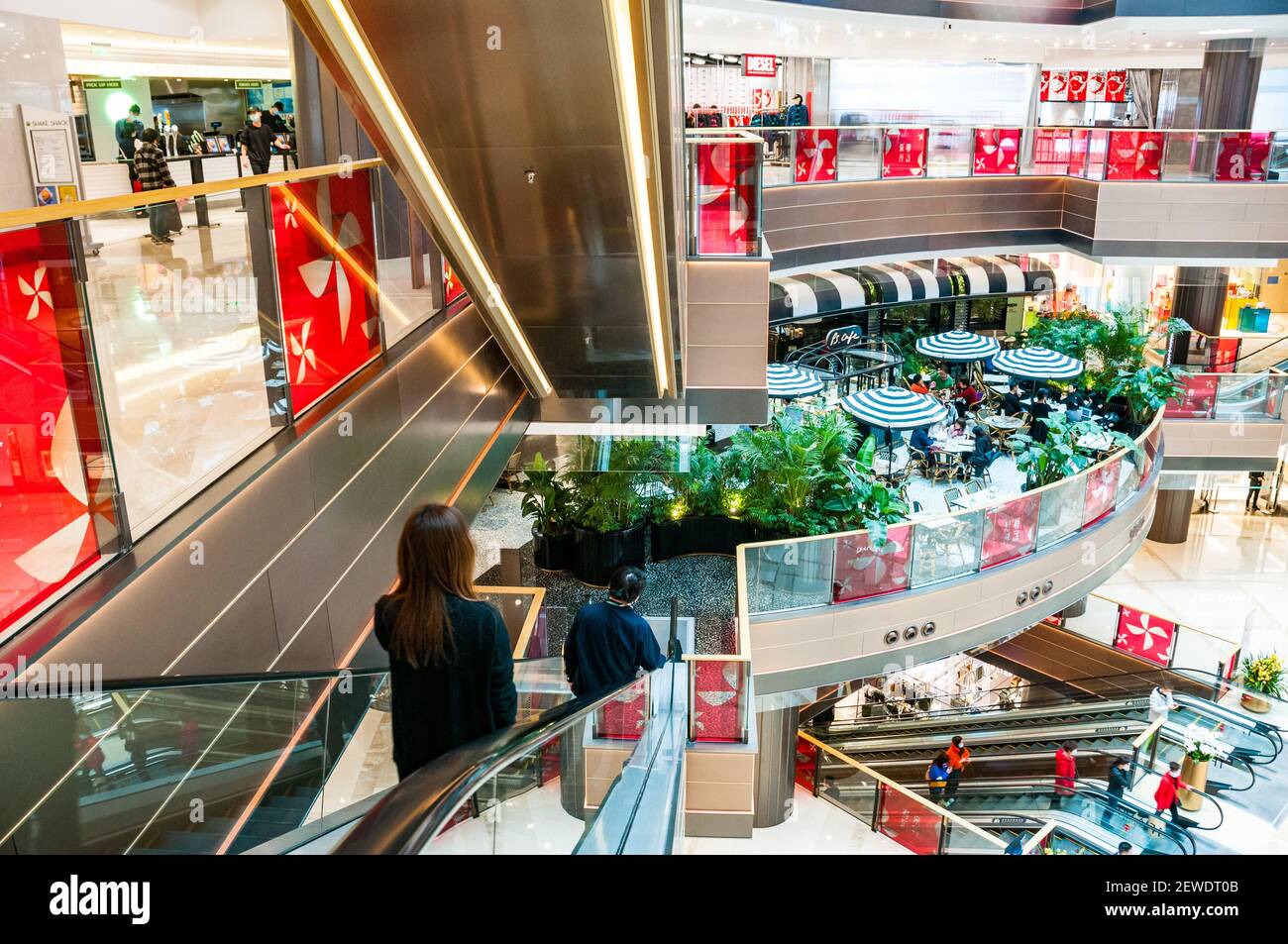 People going down an escalator in the Grand Gateway 66 shopping mall ...