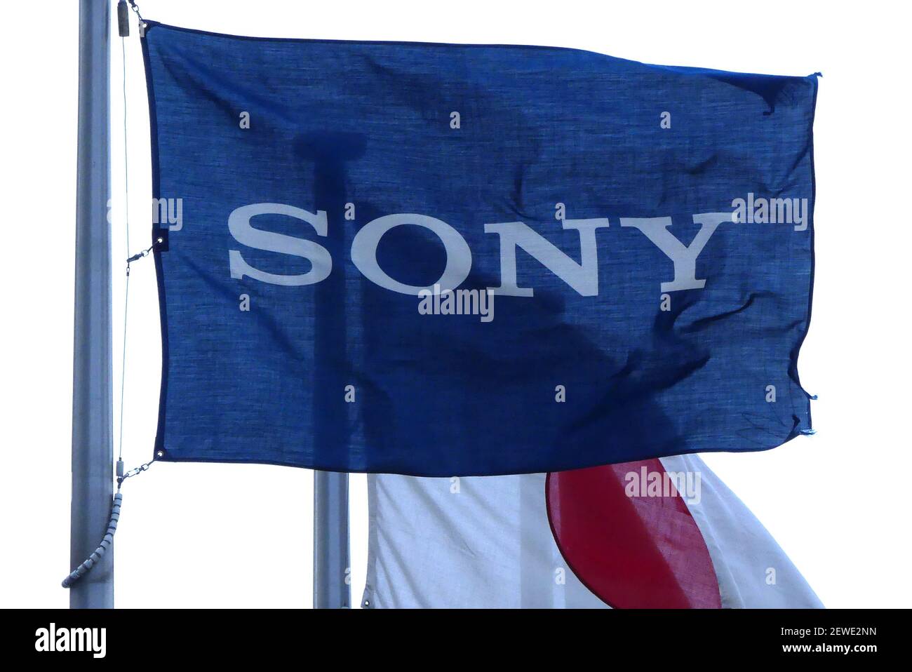 A flag with logo of Sony Corporation and a Japanese national flag fly ...