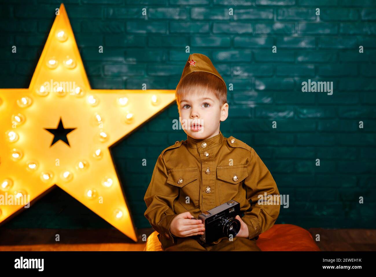 Child taking photos in professional photo studio. Young photographer ...