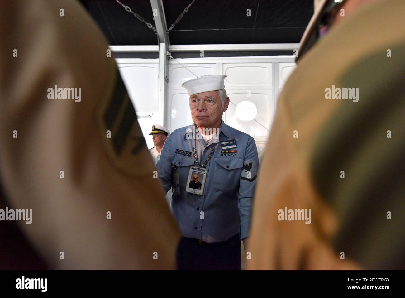 Members of the armed services furl a 50-foot U.S. Flag marking the end ...