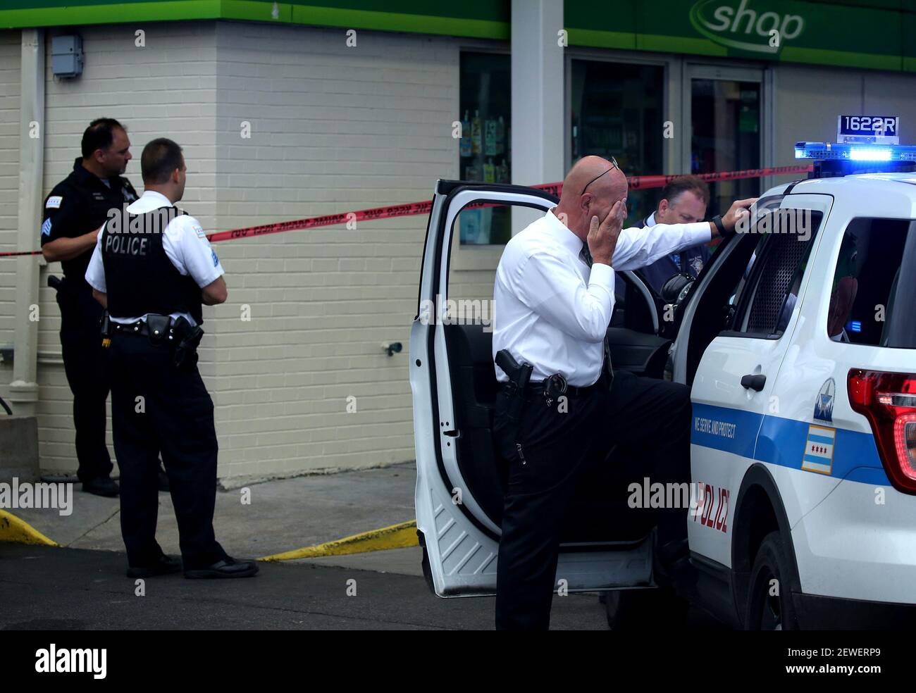 Police at the scene of a fatal shooting inside a gas station in the ...