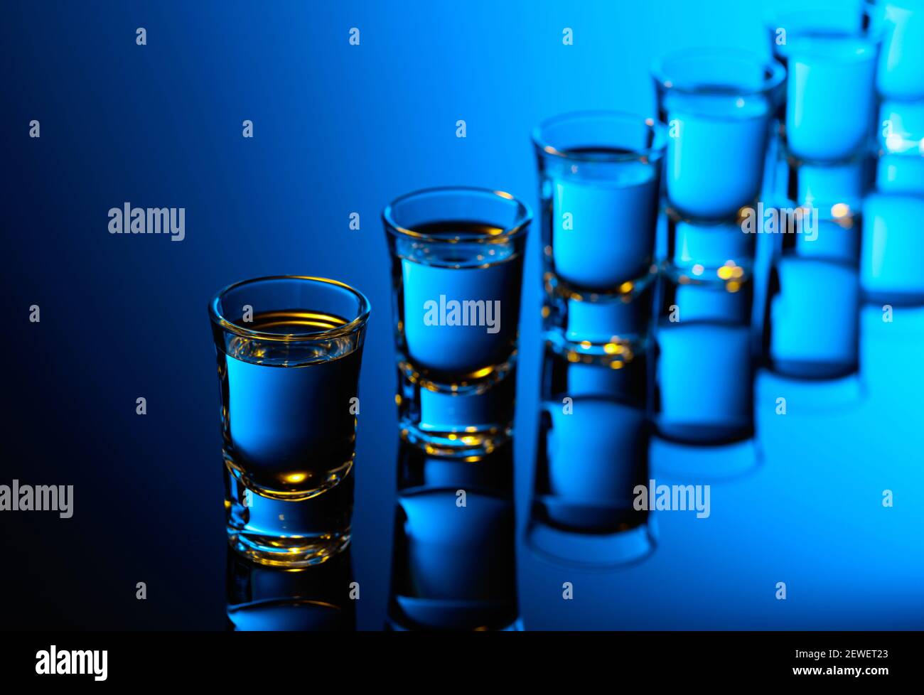 Vodka on a black reflective background. Strong alcoholic drink in color ...