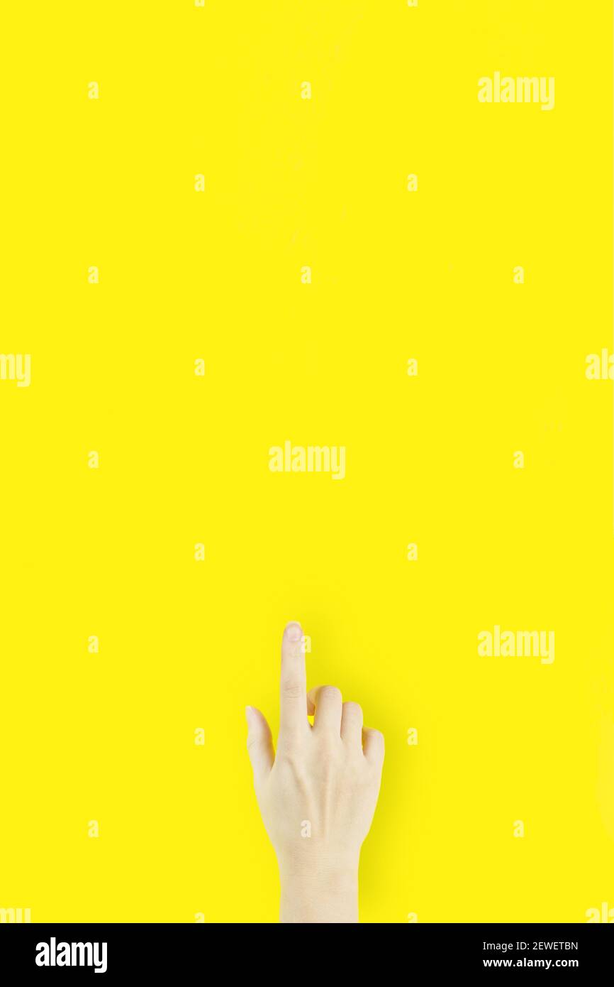 Hand Pointing Against Yellow Background. Index Finger Pointing Forward ...