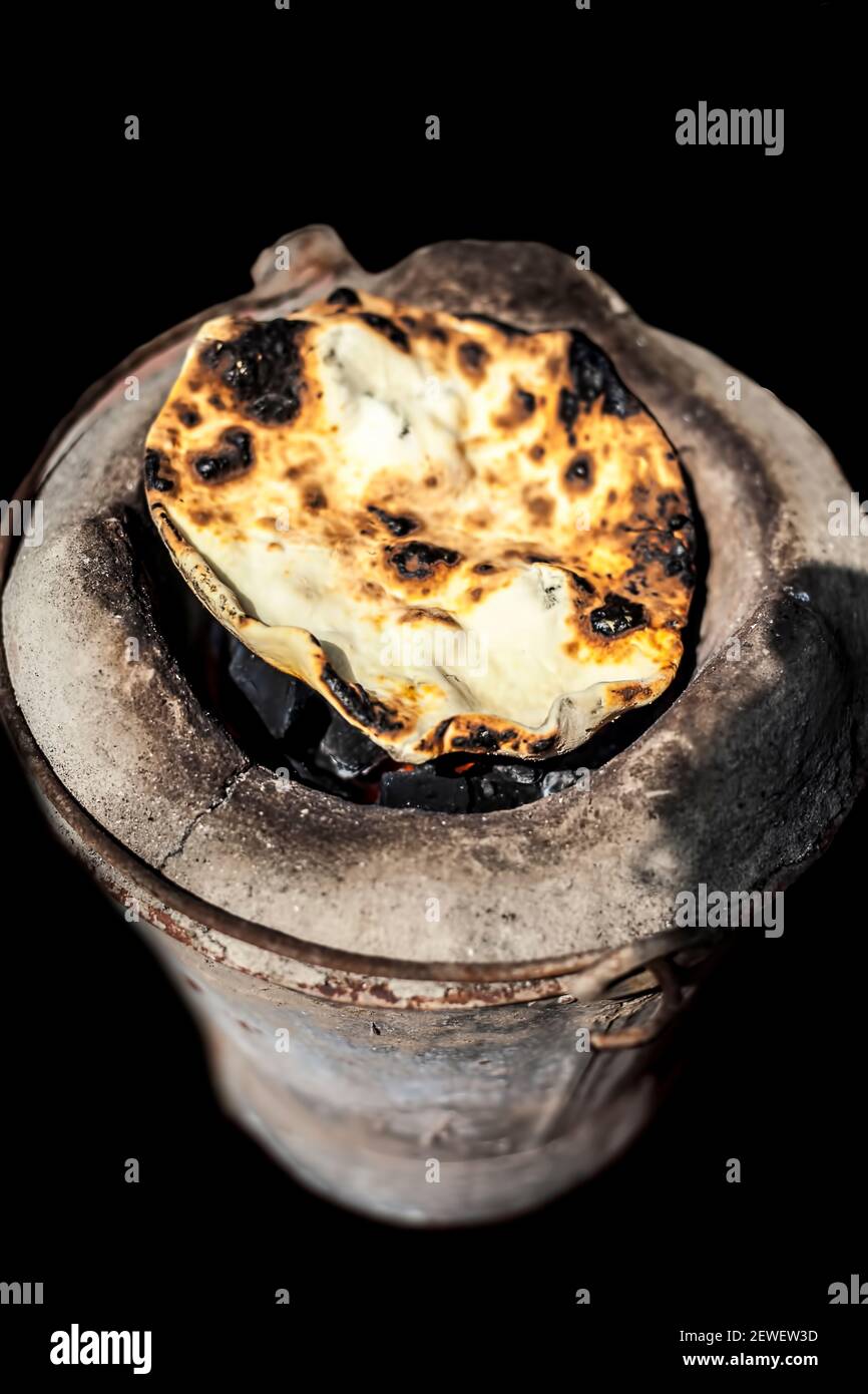 Shot of tandoori roti on old style cooking sigdi Stock Photo - Alamy