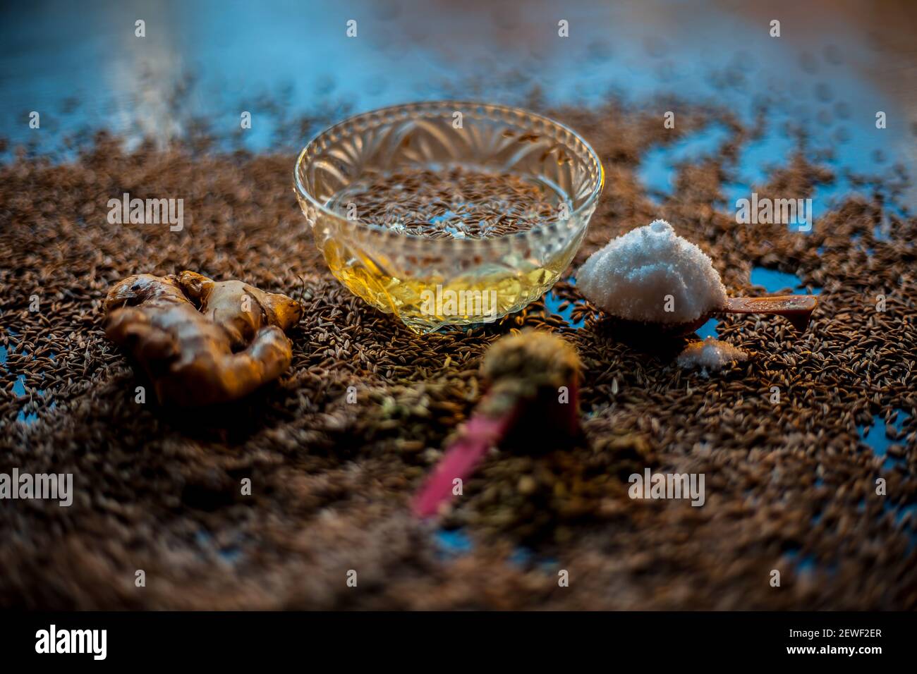 Shot of cumin seeds, sea salt, ginger powder,fennel seeds on brown ...