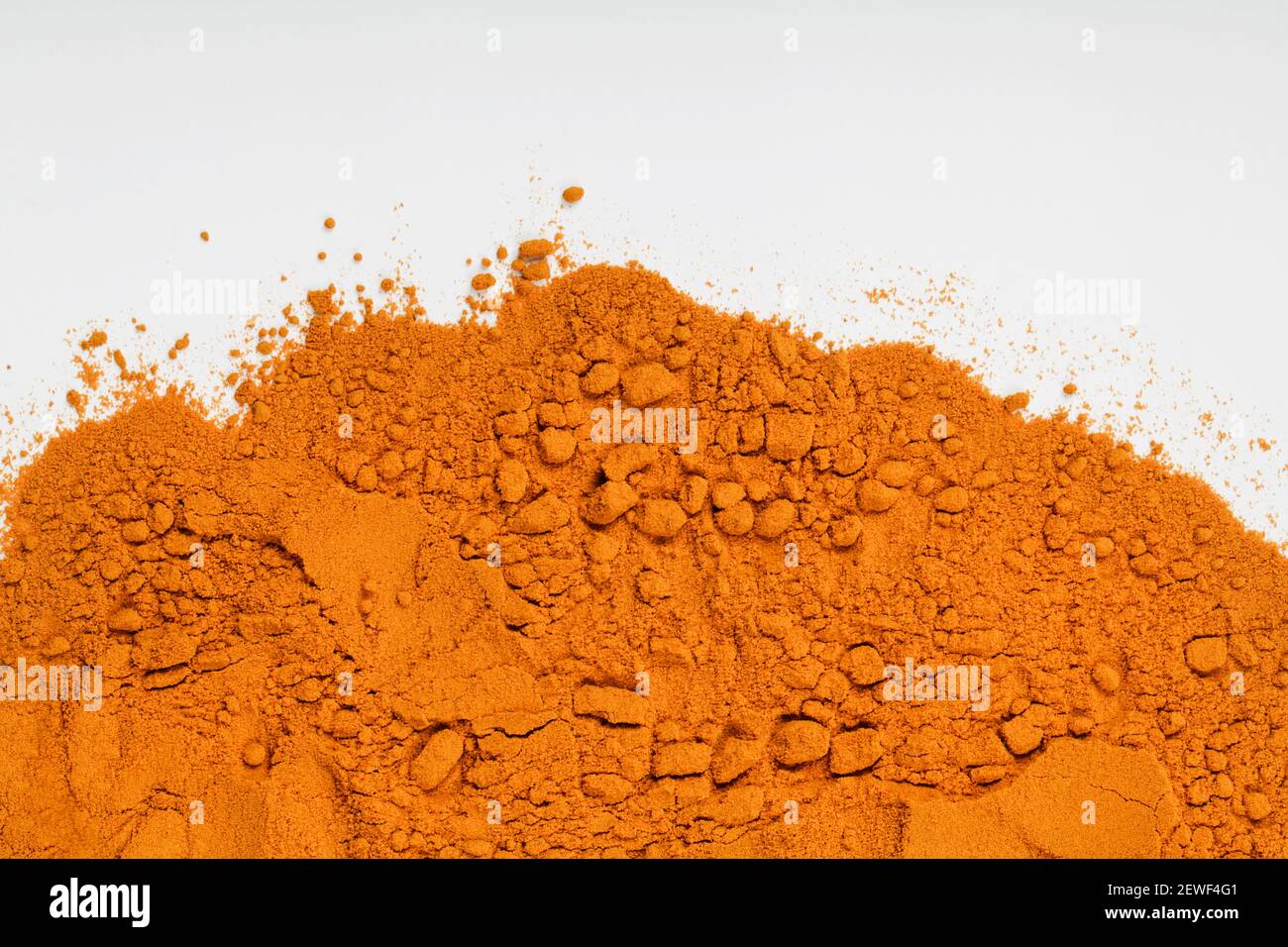 yellow curcuma or turmeric powder on white background. top view. copy ...