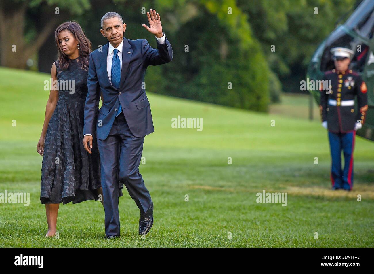 U.S. President Barack Obama and first lady Michelle Obama walk across ...