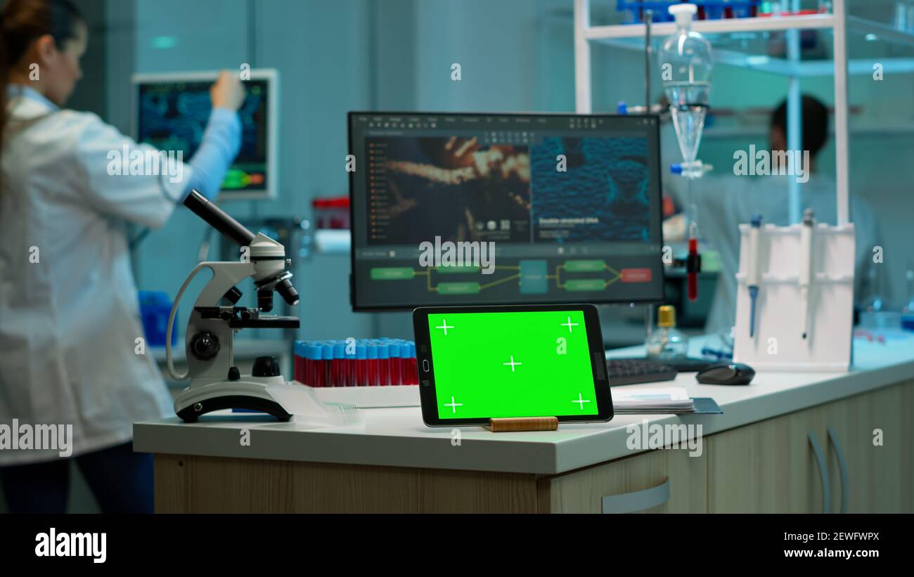 Notepad with green screen working in labooratory with mock up monitor ...