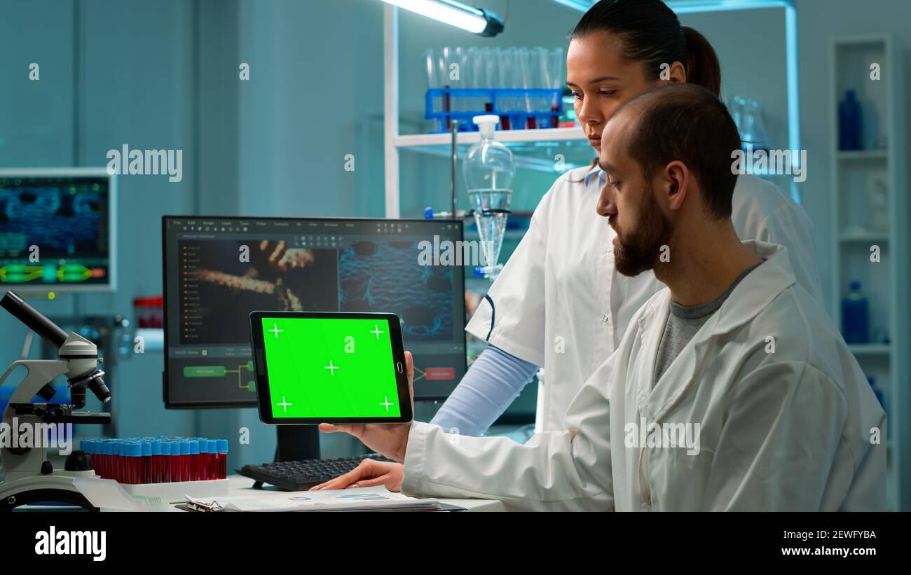 Man research scientist has conversation with famale bioengineer next to ...