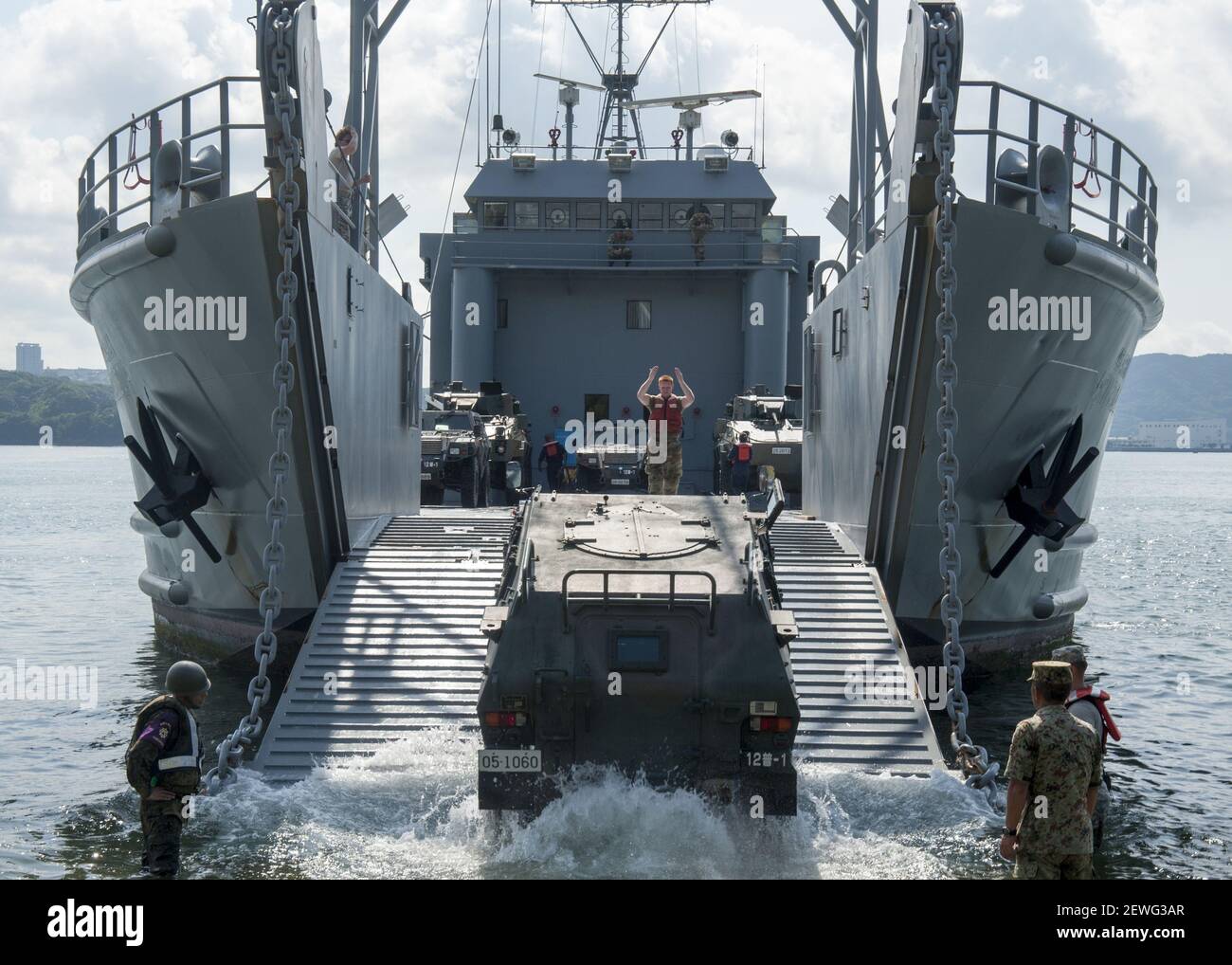 U.S. Army Spc. Michael Breneman signals to a Japan Ground Self Defense ...