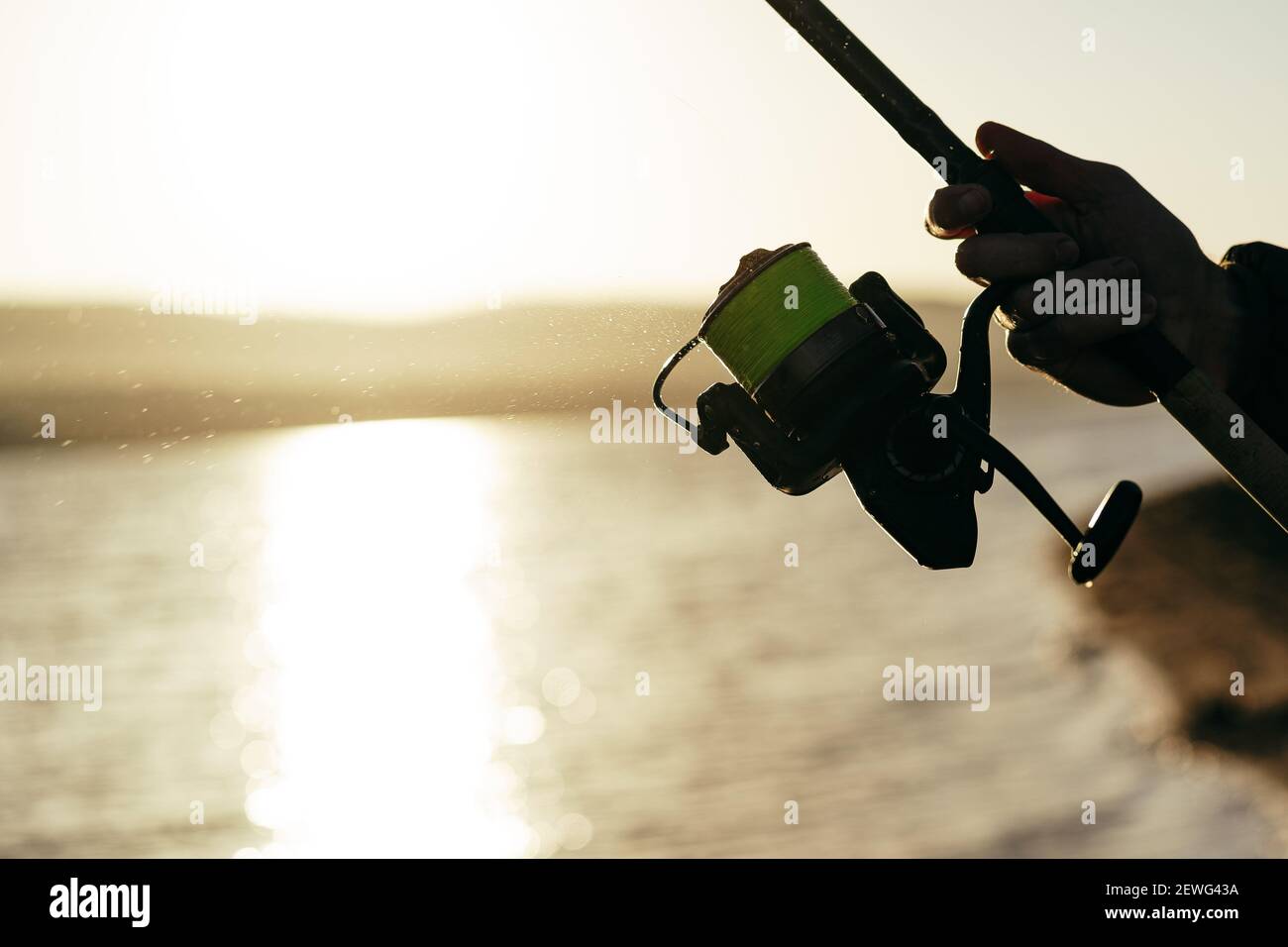 Fisherman hands holding fishing rod close up Stock Photo - Alamy