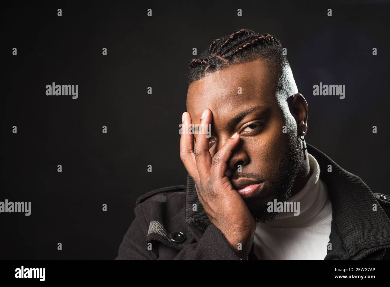 Bored and half asleep black man with his hand on his face. Close up ...