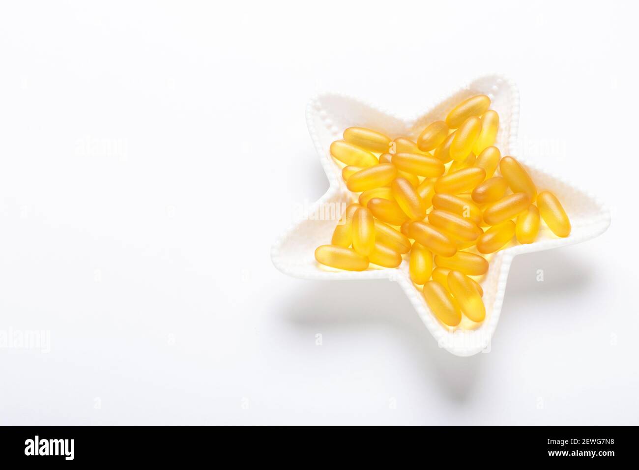 Omega 3 capsules in star shape plate on white background Fish oil ...