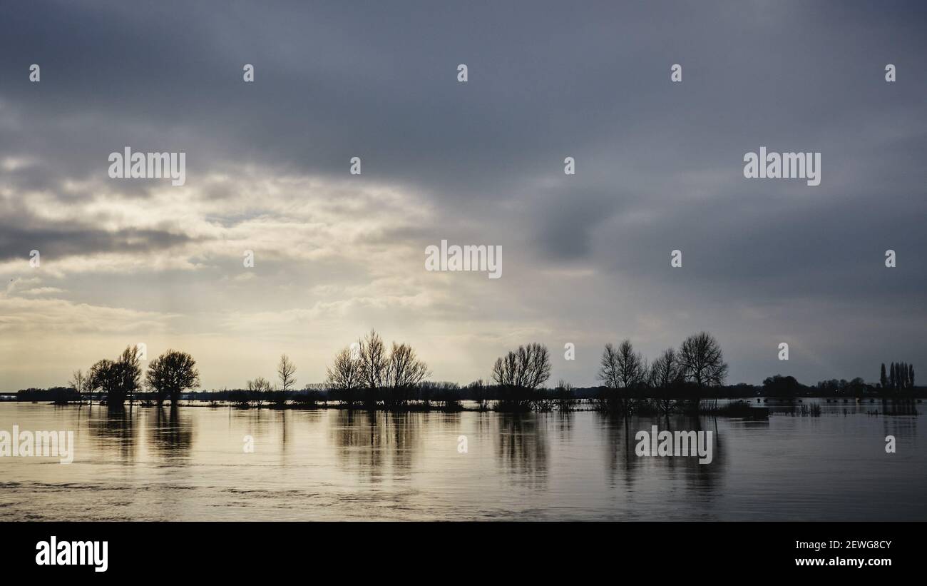 A mesmerizing view of a calm lake under a cloudy sky Stock Photo - Alamy