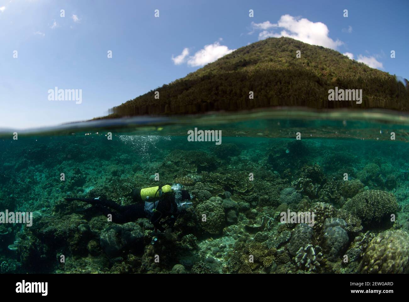 Diver with camera with Manado Tua volcano in background, Bualo dive ...
