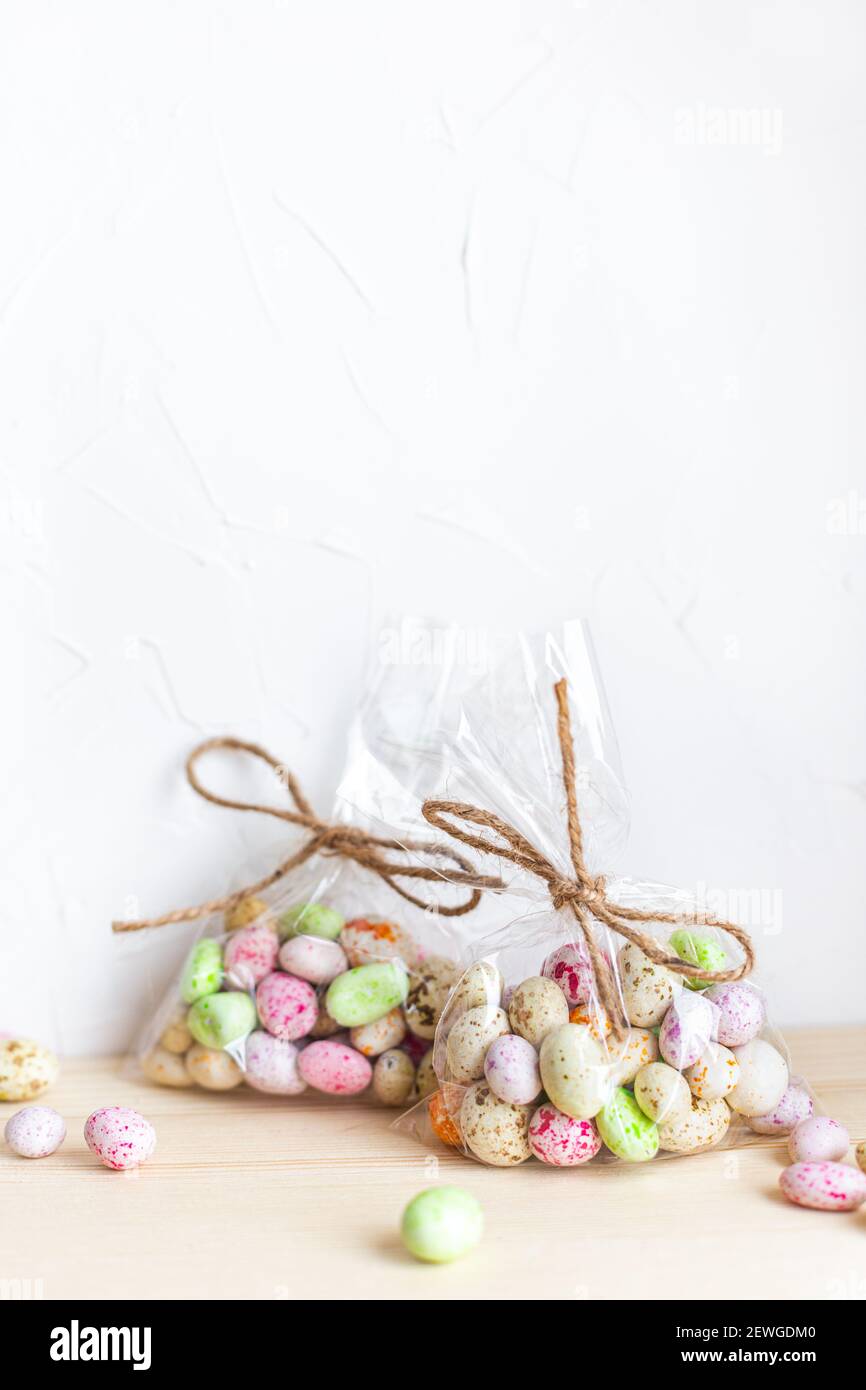 Chocolate Easter eggs, candy in glaze in a transparent bag on a light ...