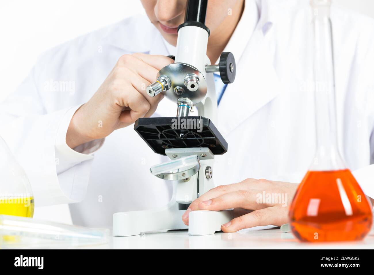 Scientist looking through microscope in laboratory Stock Photo - Alamy