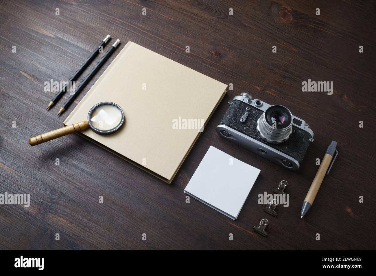 Photo of blank vintage stationery and retro camera on wooden background ...