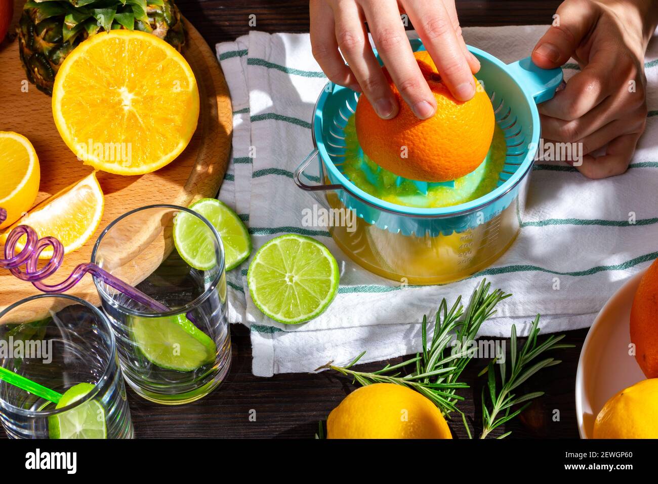 The process of squeezing juice from an orange. Women's hands squeeze ...