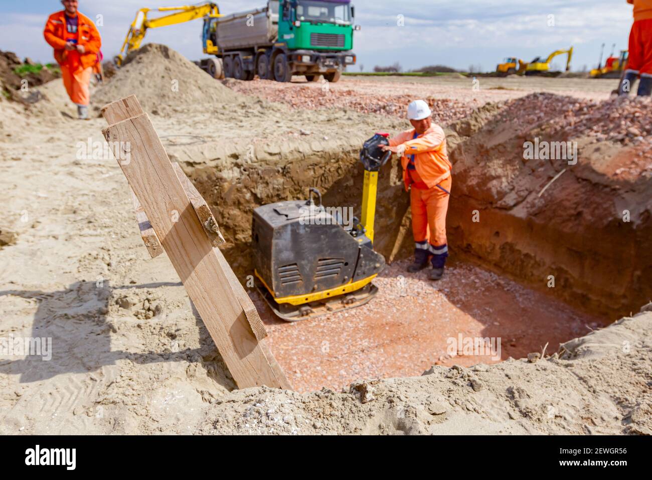 Wooden ladders for worker to exit after compacting gravel with ...