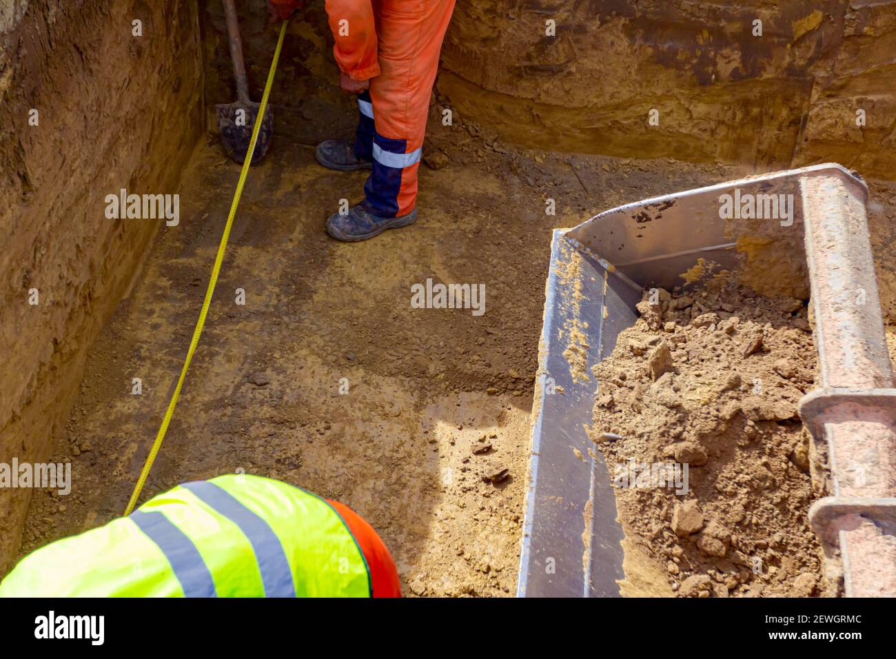 Workers are using metal measure tape, meter to check measurement in ...