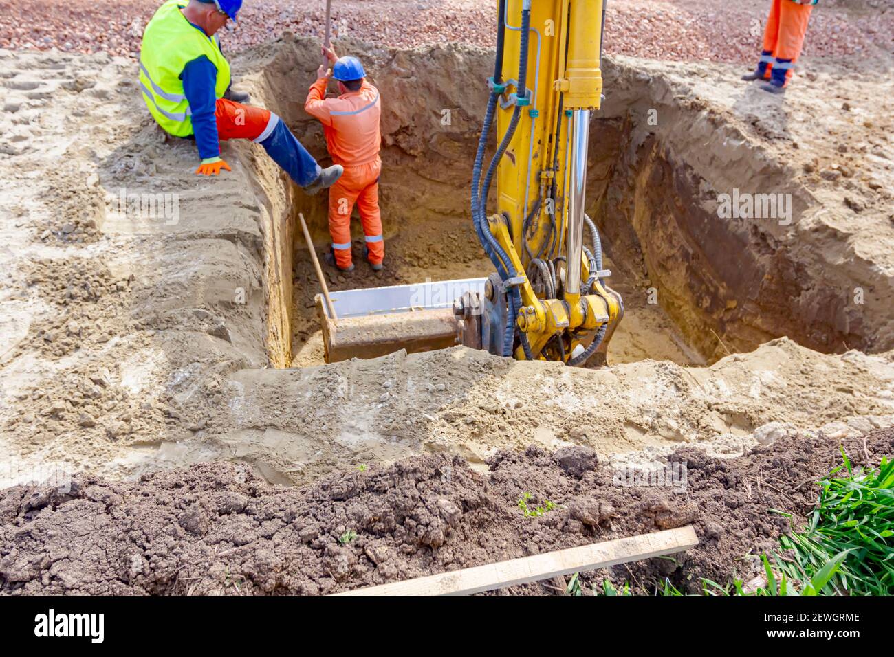 Workers are using shovels for realign excess of ground to correct ...