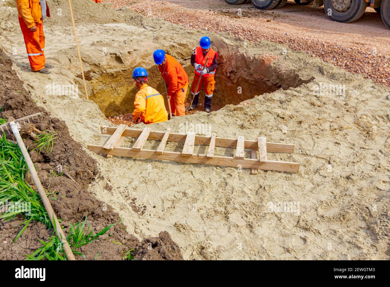 Workers are using shovels to set up level foundation to right measures ...