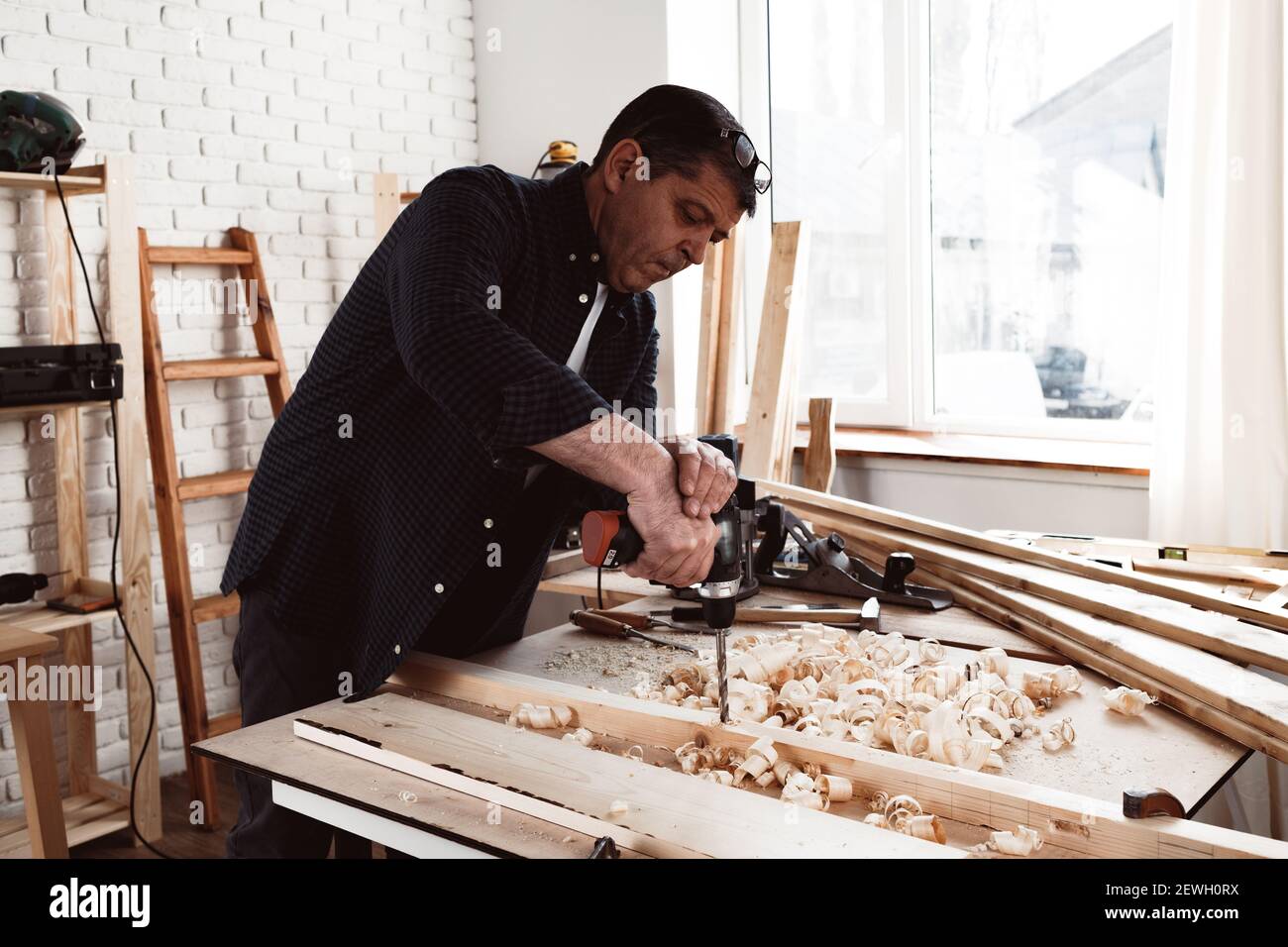 Close up of a carpenter drilling a hole in timber Stock Photo - Alamy