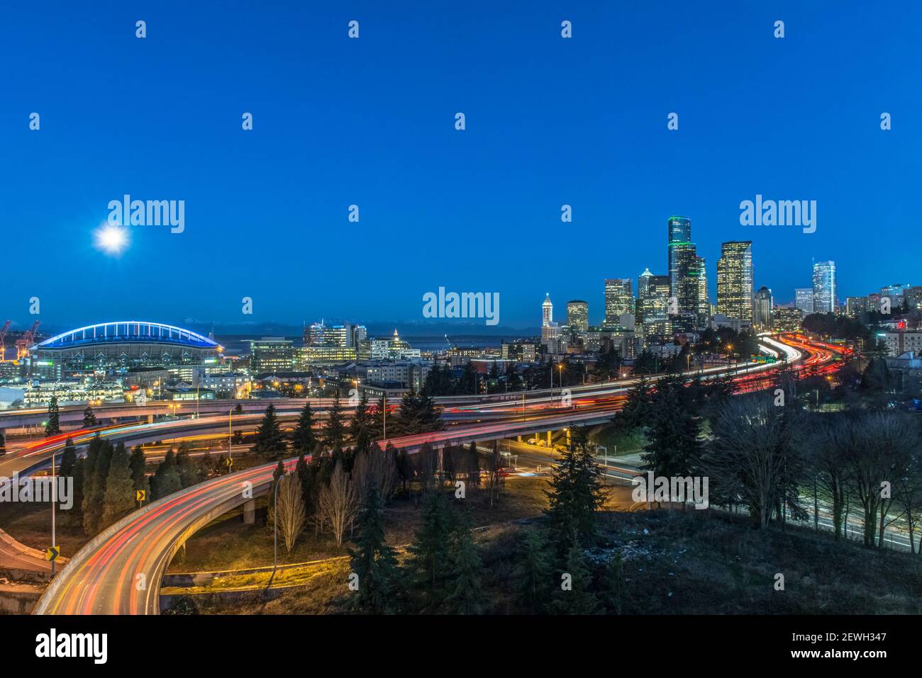 The city skyline of Seattle at night, road and bridge, downtown ...