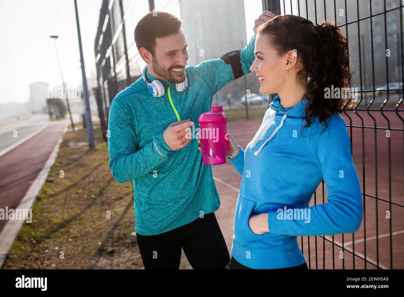 Fitness, sport, friendship and lifestyle concept. Smiling sporty couple ...