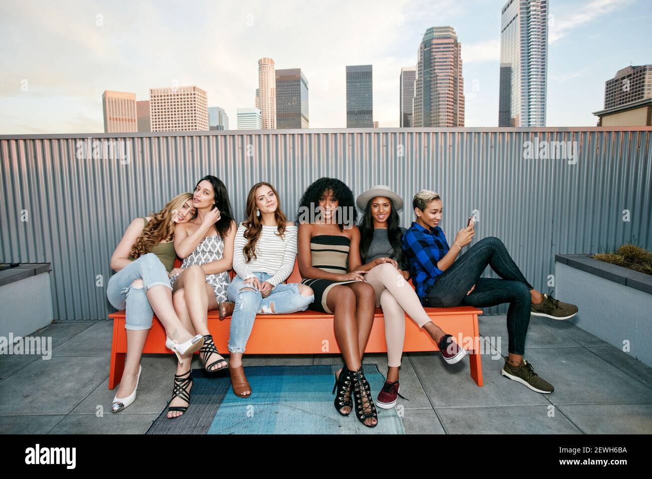 A group of young women partying on a city rooftop at dusk Stock Photo ...