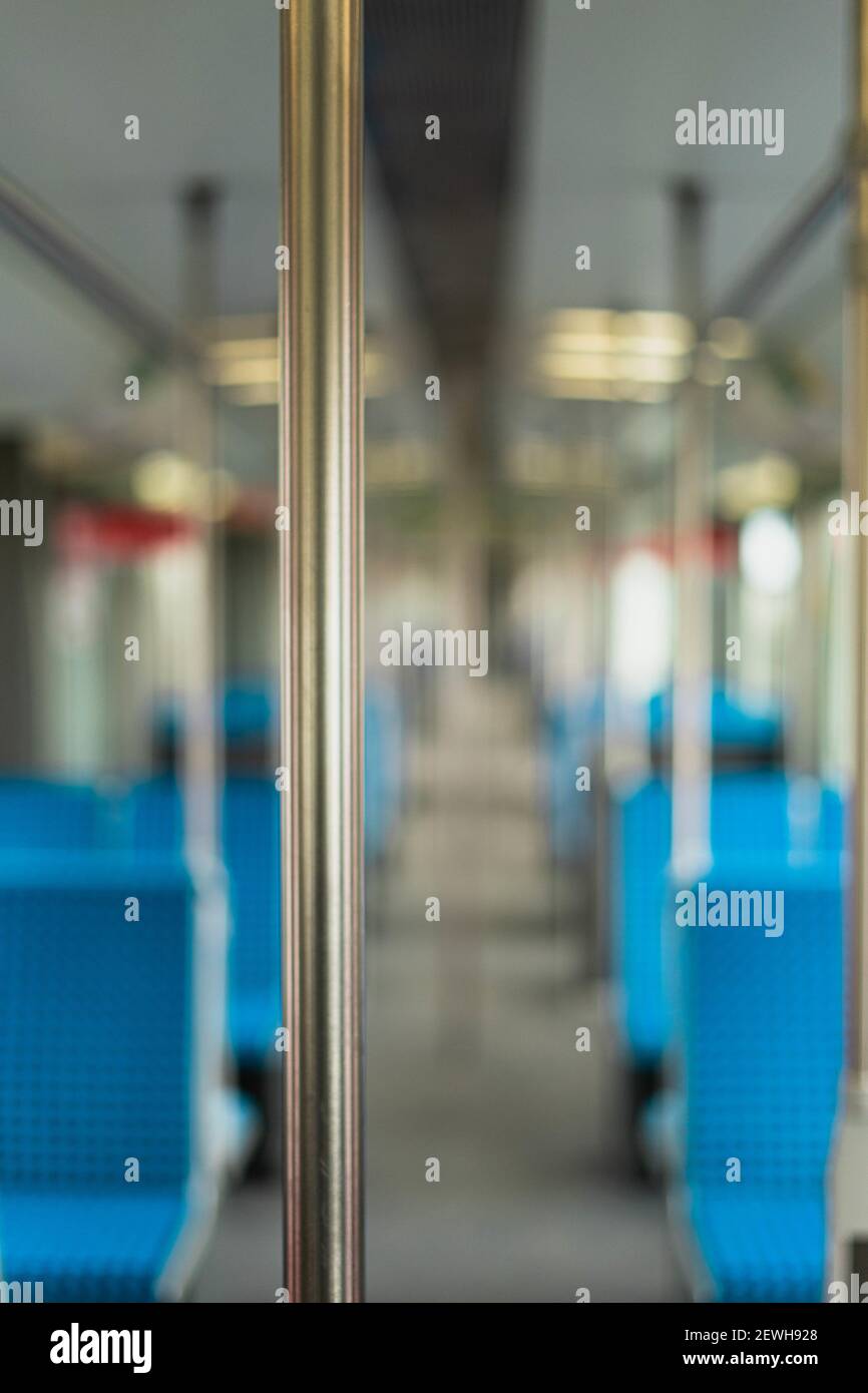 A modern city public bus interior with comfortable empty seats and ...