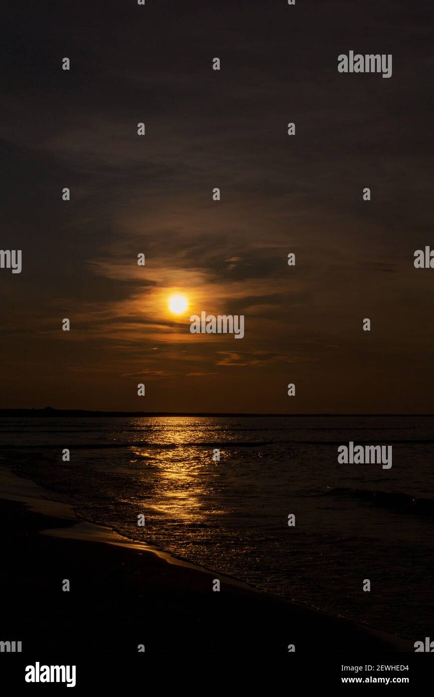 A beautiful view of the wavy Baltic Sea gleaming under the shiny sunset ...