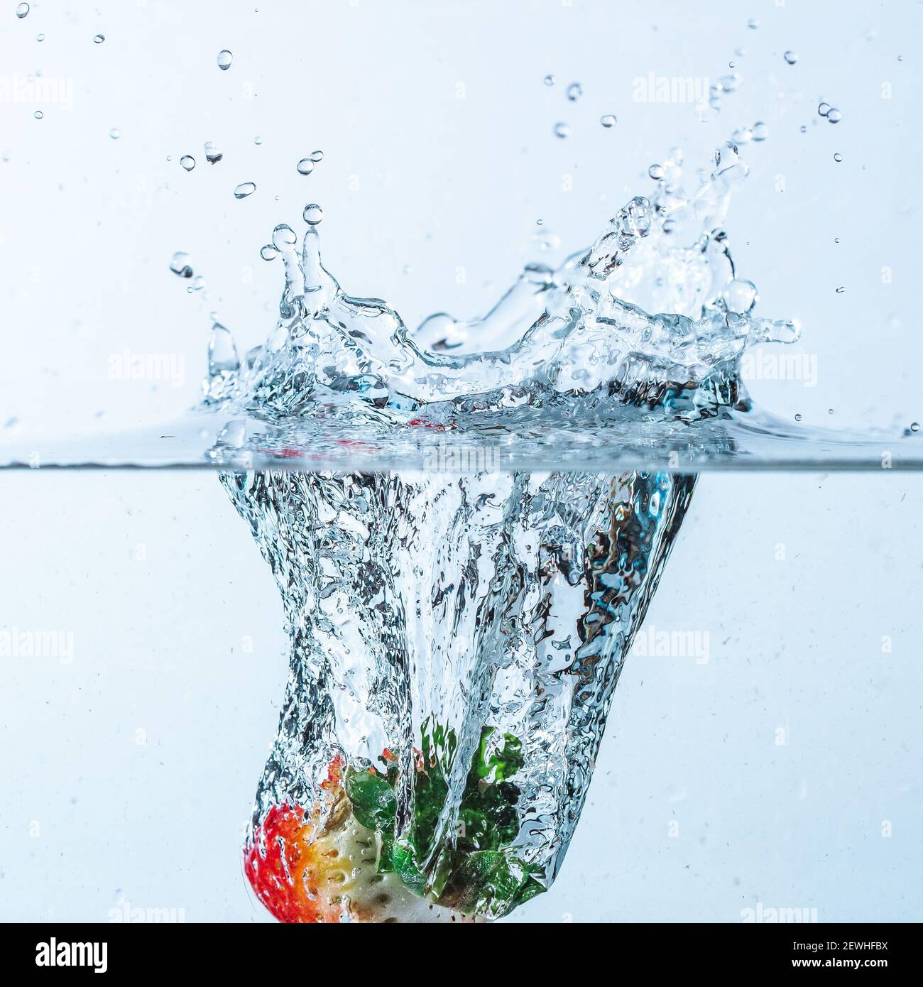 A mandarin falling into water with a splash Stock Photo - Alamy
