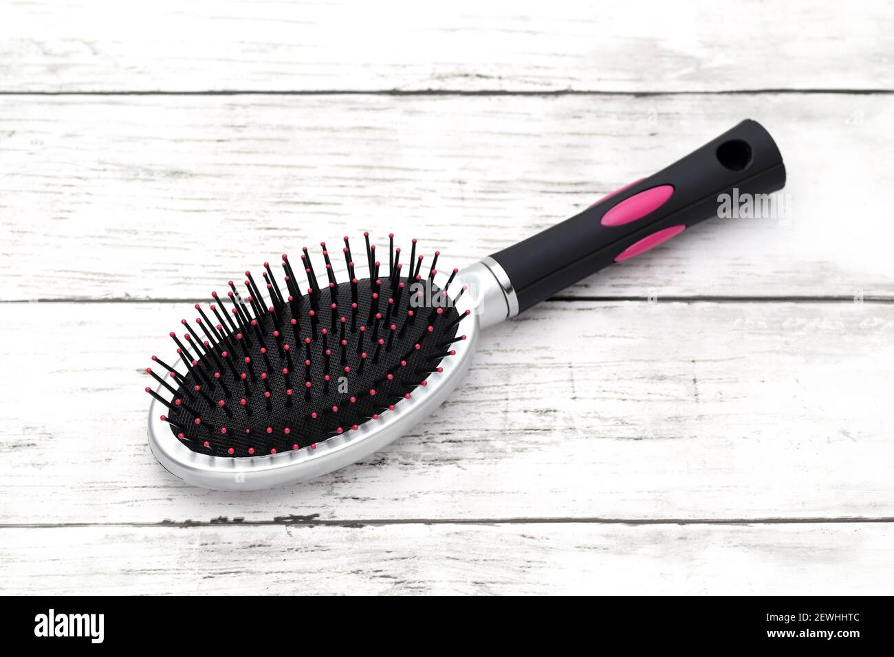 Fashionable female comb for hair care on a white wooden table Stock ...