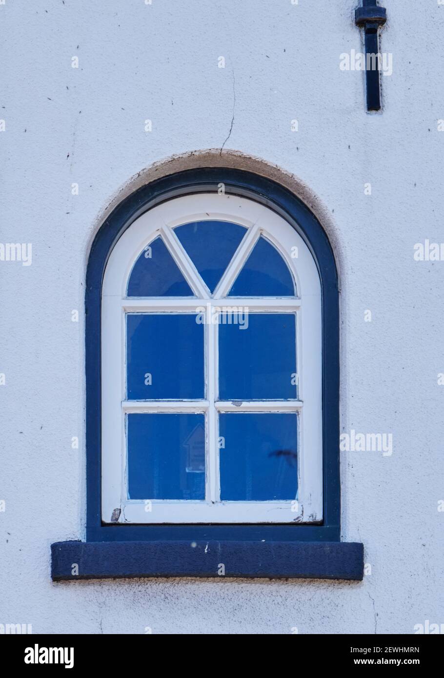 An old wooden window of a lighthouse. The green and white paint is ...
