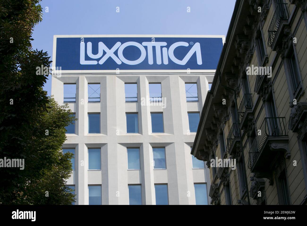 A logo sign outside of the headquarters of the Luxottica Group S.p.A ...