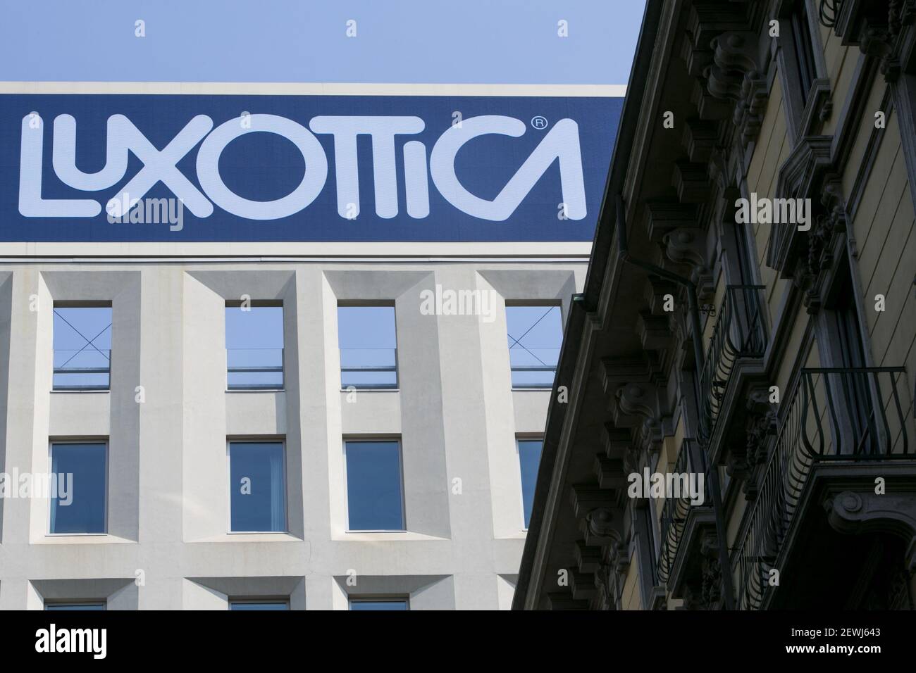 A logo sign outside of the headquarters of the Luxottica Group S.p.A ...