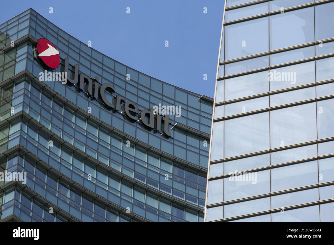 A logo sign outside of the headquarters of the UniCredit Group in Milan ...
