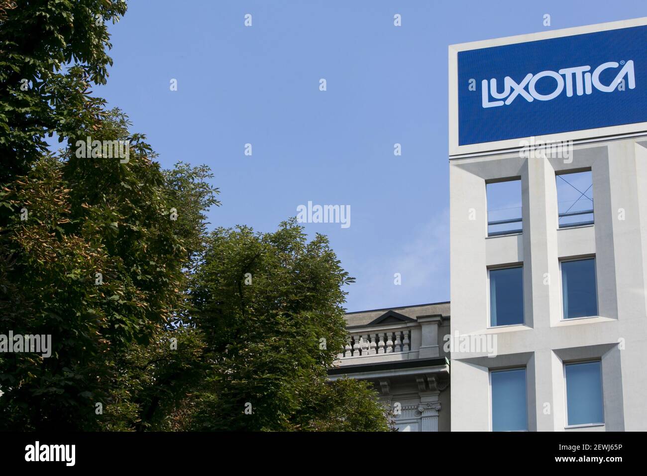 A logo sign outside of the headquarters of the Luxottica Group S.p.A ...