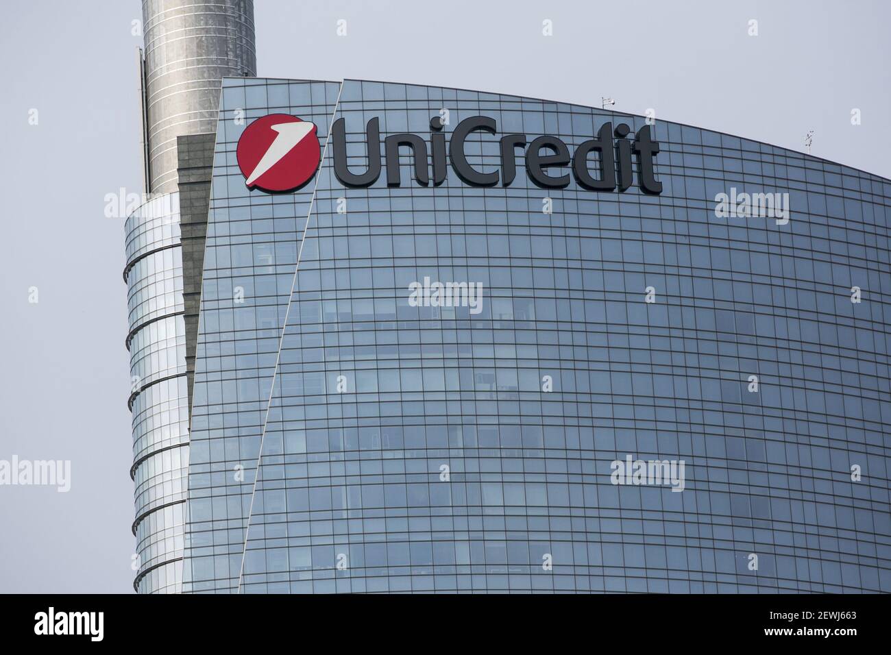 A logo sign outside of the headquarters of the UniCredit Group in Milan ...