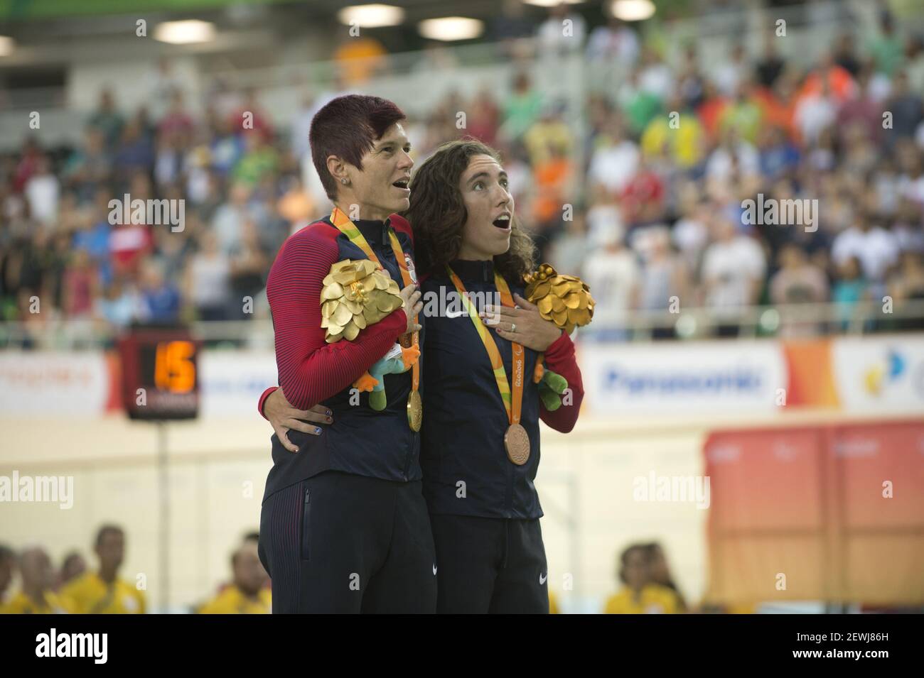 Americans Shawn Morelli(L) and Megan Fisher(R) sing the national anthem ...