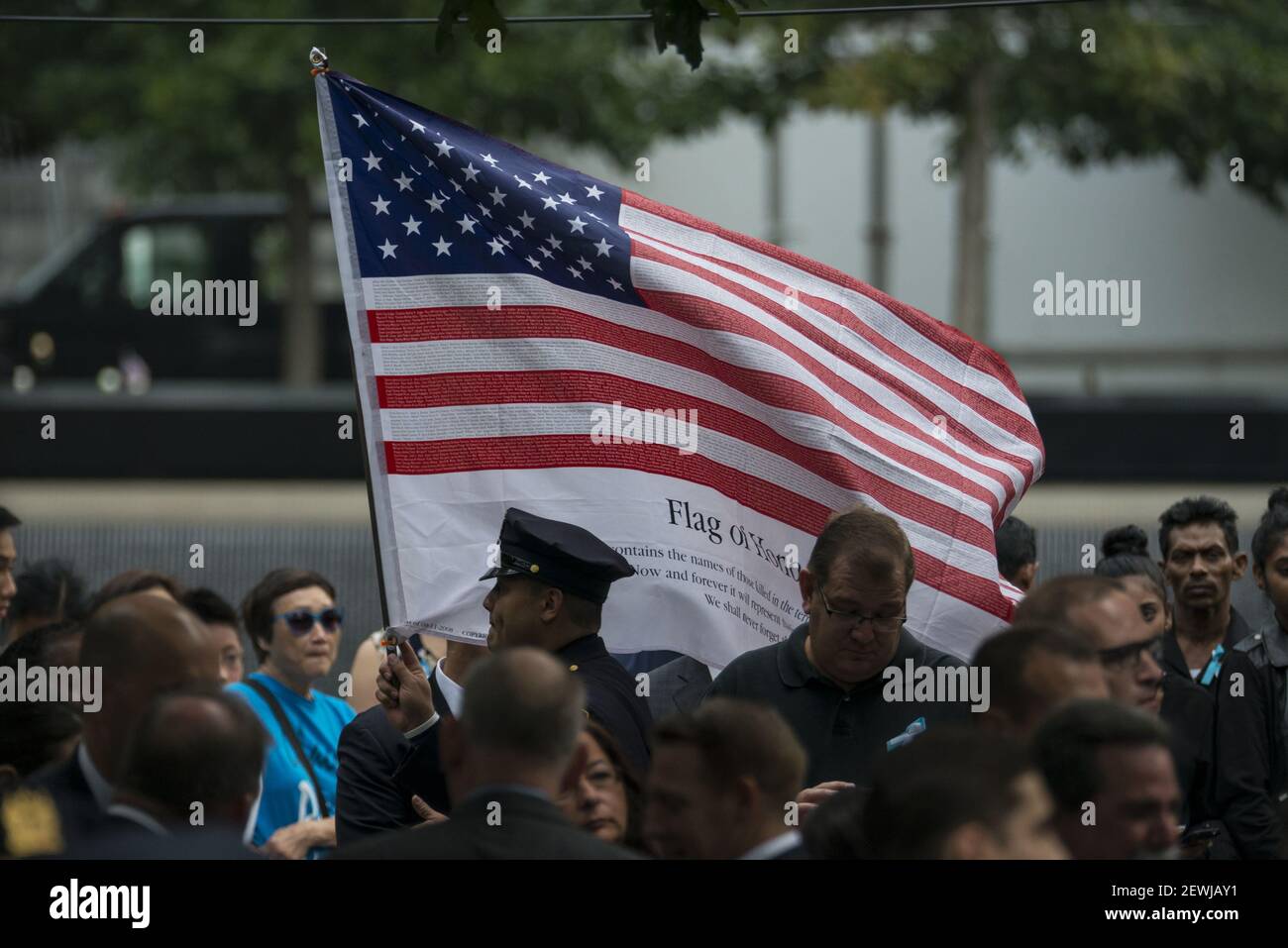A flag is carried around the periphery of one of the World Trade Center ...