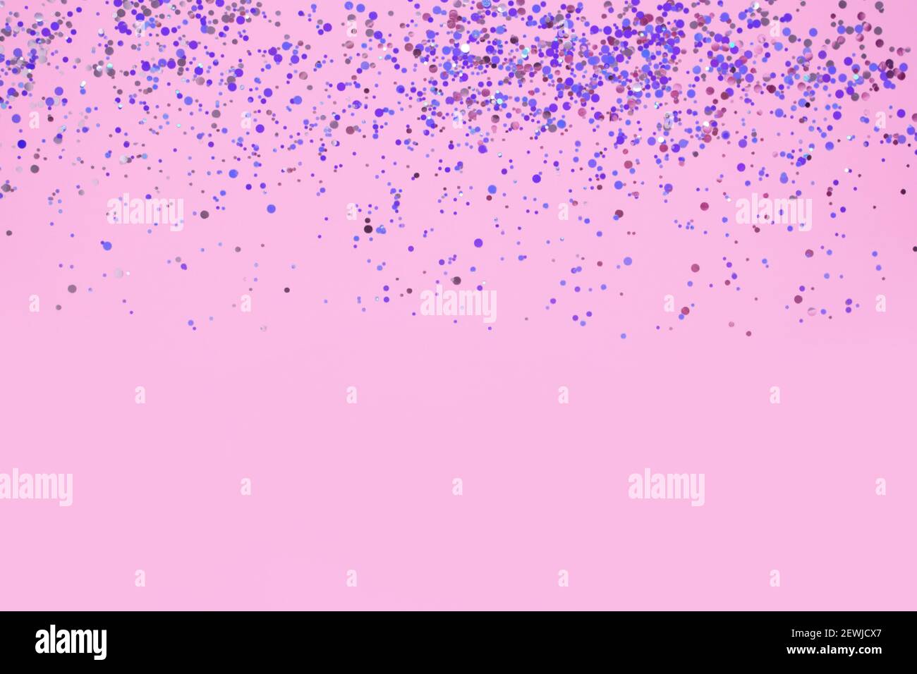 Festive pink background with multicolored blue and purple sparkles for ...