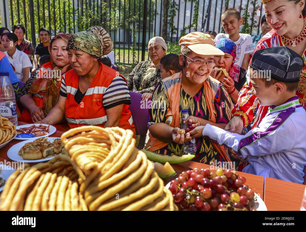 Residents of a community enjoy food to celebrate the Corban Festival in ...